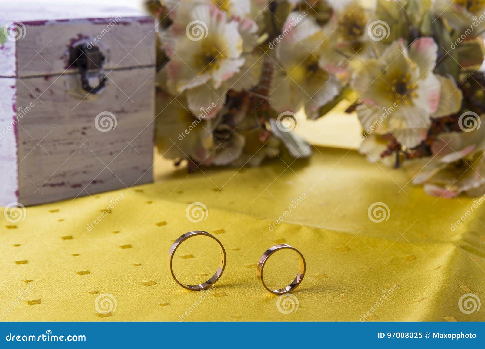 Closeup of Wedding Rings on the Yellow Tablecloth Stock Image - Image ...
