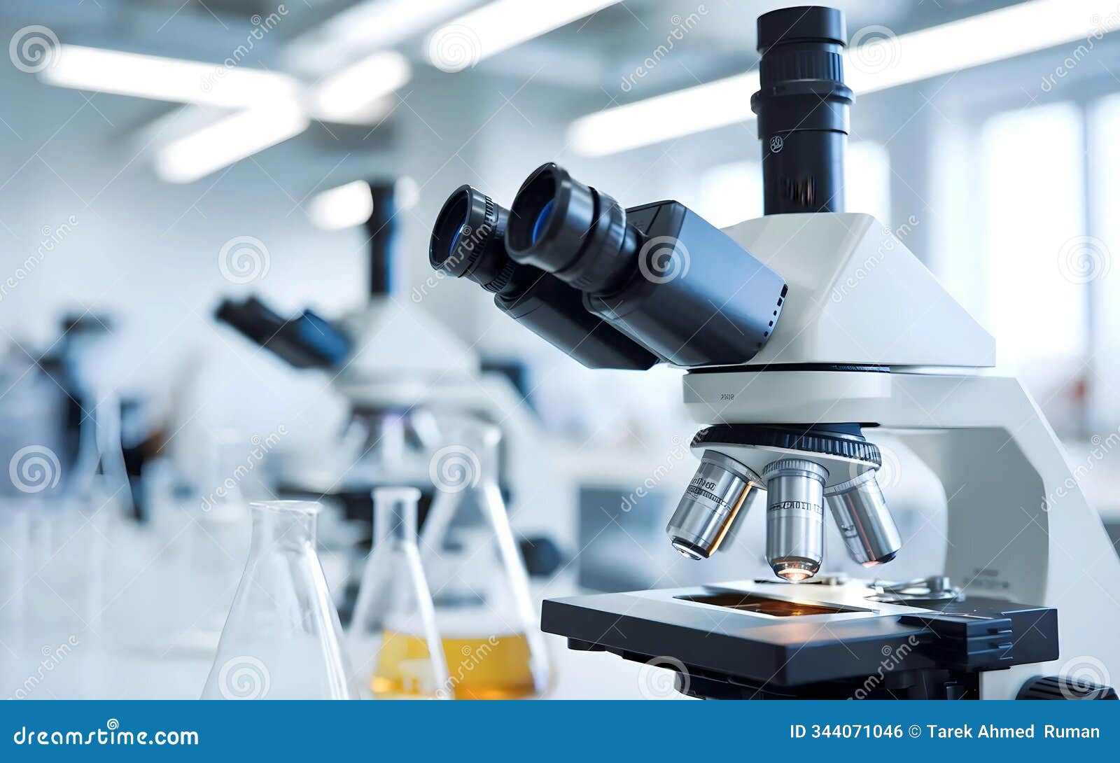 A Closeup of a White Laboratory Microscope with Black Lenses ...