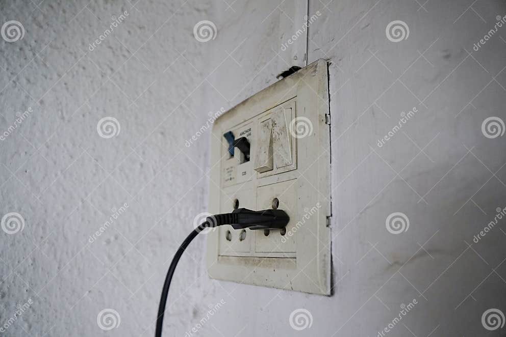 Closeup of a Wire Plugged in a Socket on a Textured White Wall Stock ...