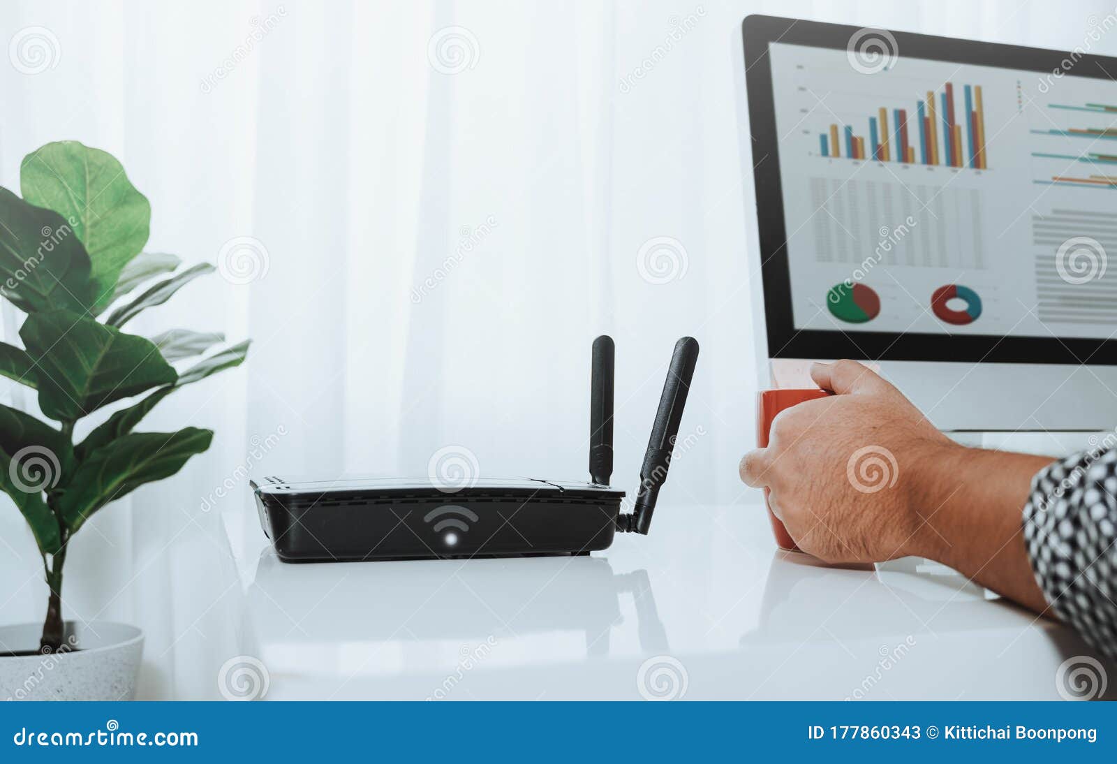 Closeup of a Wireless Router and a Man Using Computer on Living Room at ...