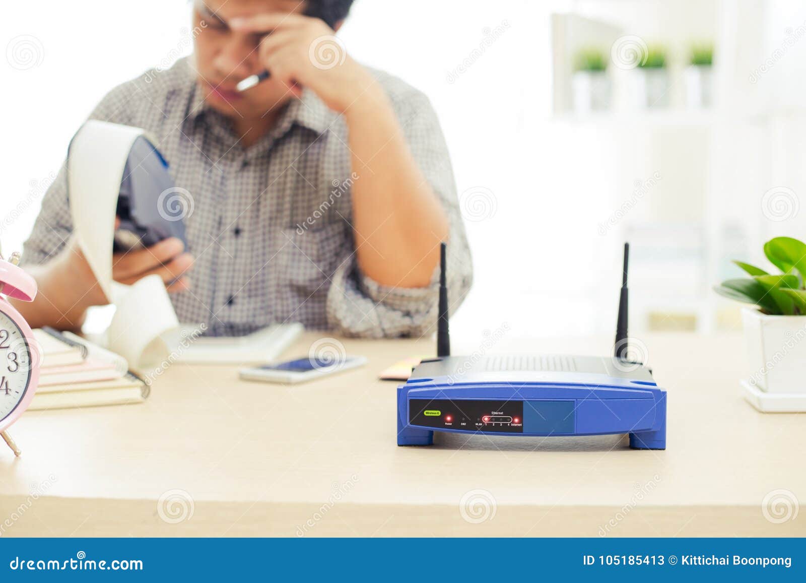 Closeup of a Wireless Router and a Man Using Machine on Ofiice, Stock ...