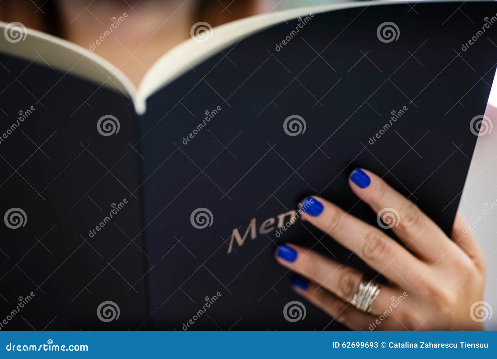Closeup of Woman Hands Holding Menu Stock Image - Image of woman, blue ...
