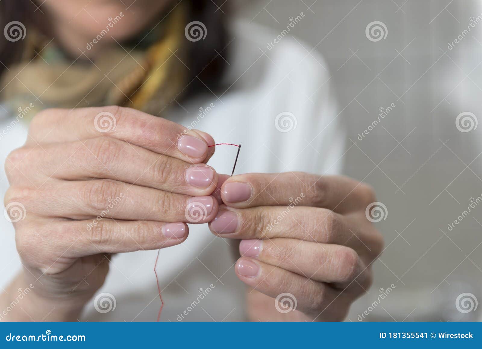 Closeup of a Woman Threading a Needle with a Red Thread Stock Image ...