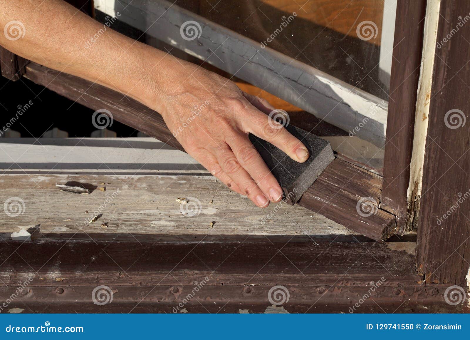 Worker sanding old window stock photo. Image of craftsman - 129741550