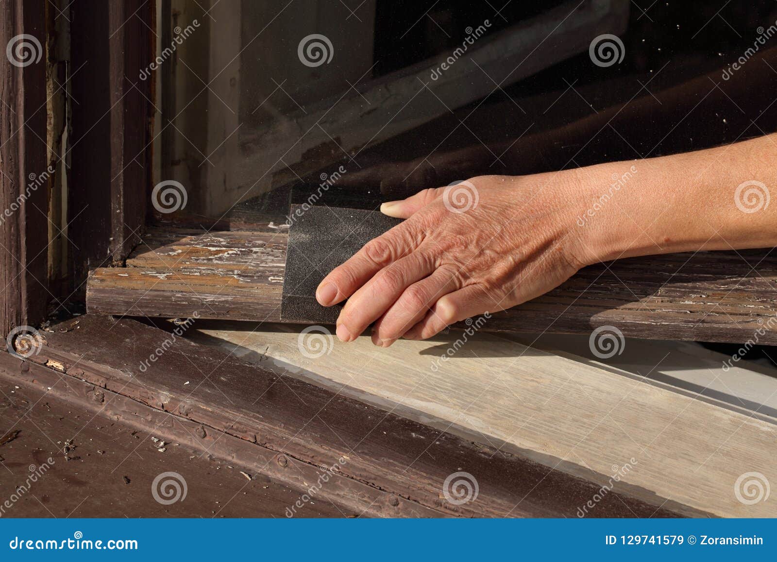 Worker sanding old window stock image. Image of closeup - 129741579