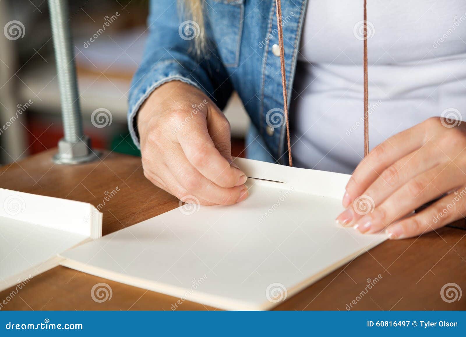 Closeup of Worker Inserting Needle in Paper Stock Image - Image of ...
