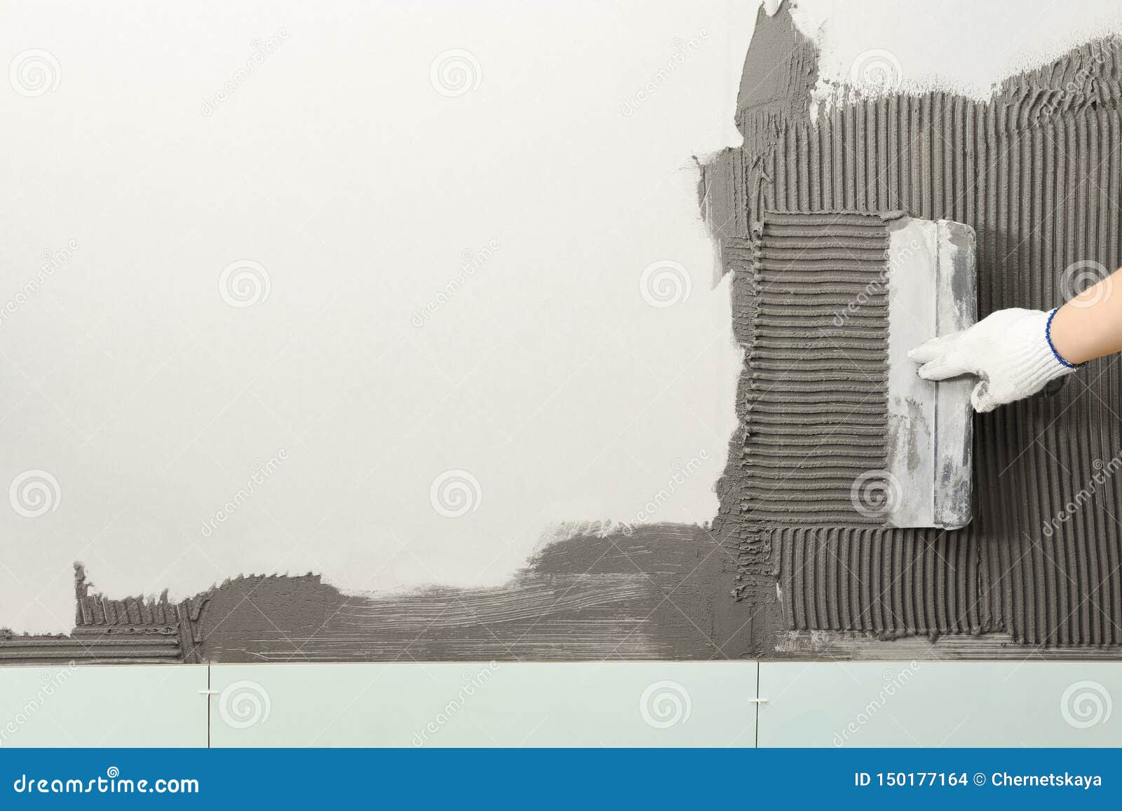 Closeup of Worker Spreading Concrete on Wall with Spatula. Tile ...