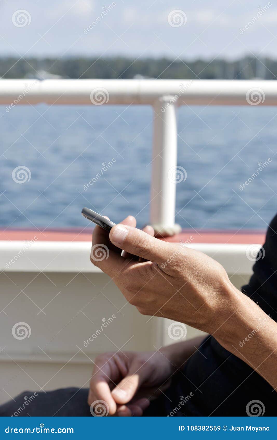 Young Man Using a Smartphone in the Deck of a Ship Stock Image - Image ...