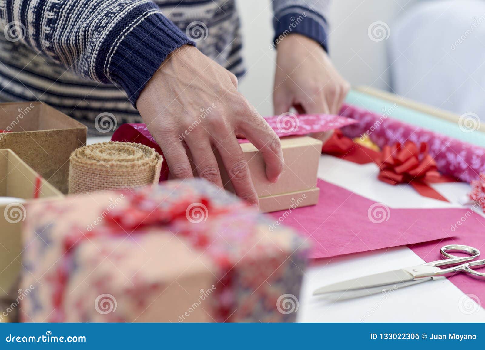 Young man wrapping a gift stock photo. Image of crafts - 133022306