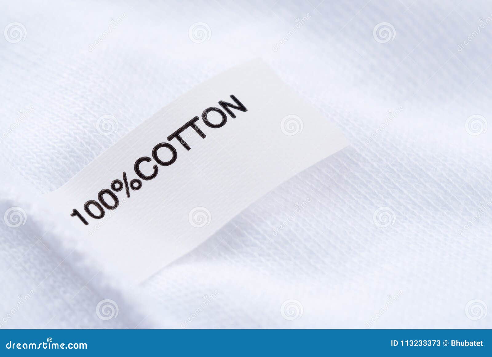 Cloth Tag 100 Cotton on White Fabric Stock Image - Image of macro ...
