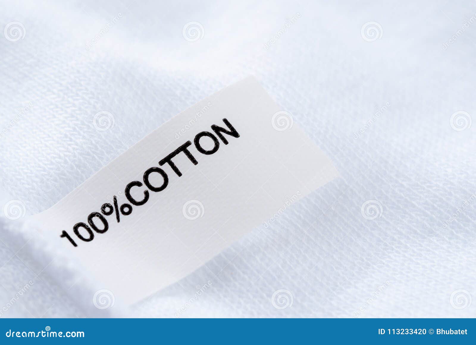 Cloth Tag 100 Cotton on White Fabric Stock Photo - Image of message ...