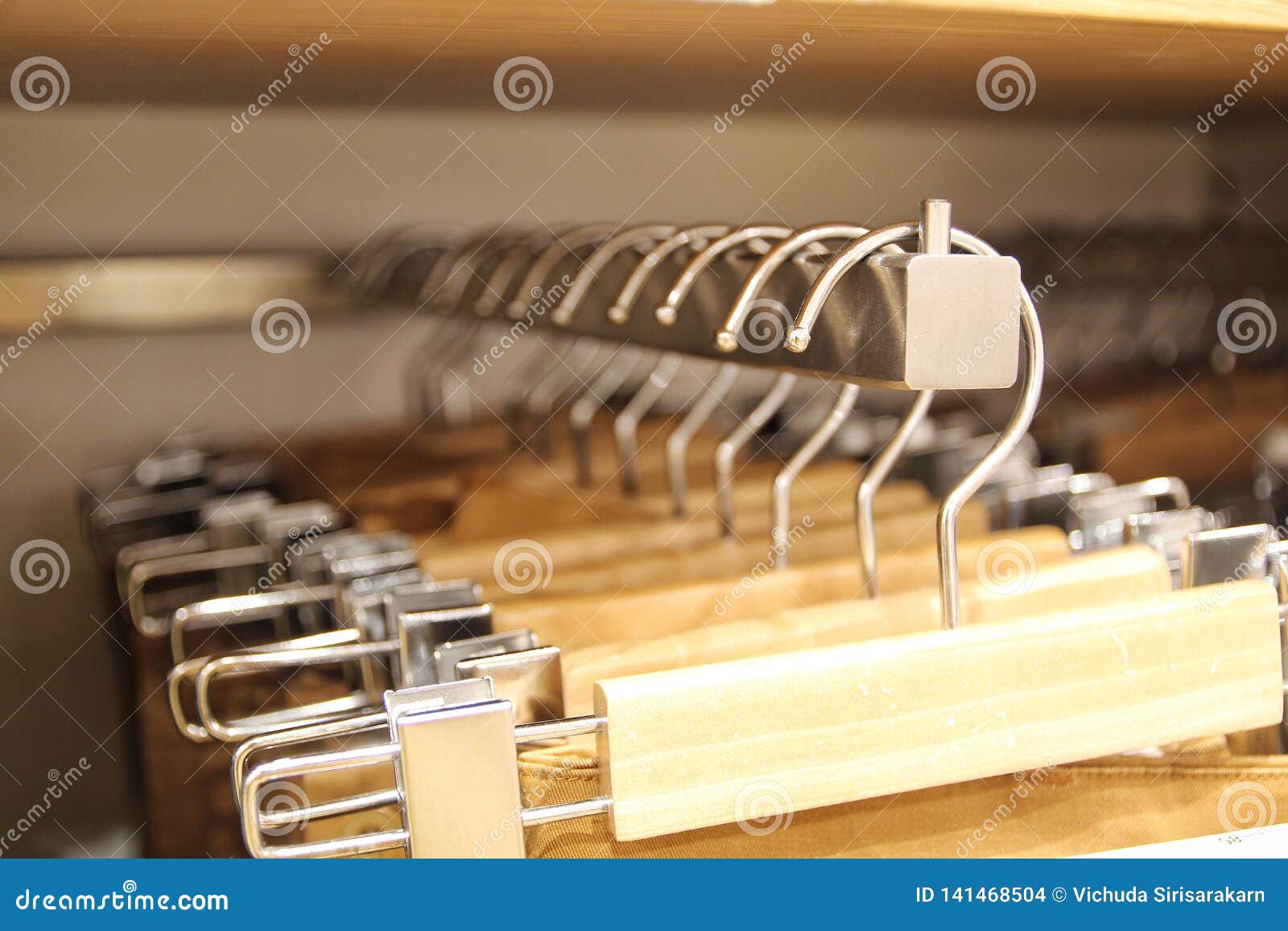 Clothe hangers on the rack stock photo. Image of cloth - 141468504