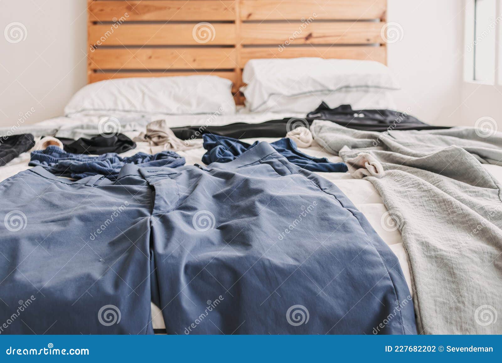 Clothes on the Bed. Concept of Housework and Clean Up Clothes Stock ...