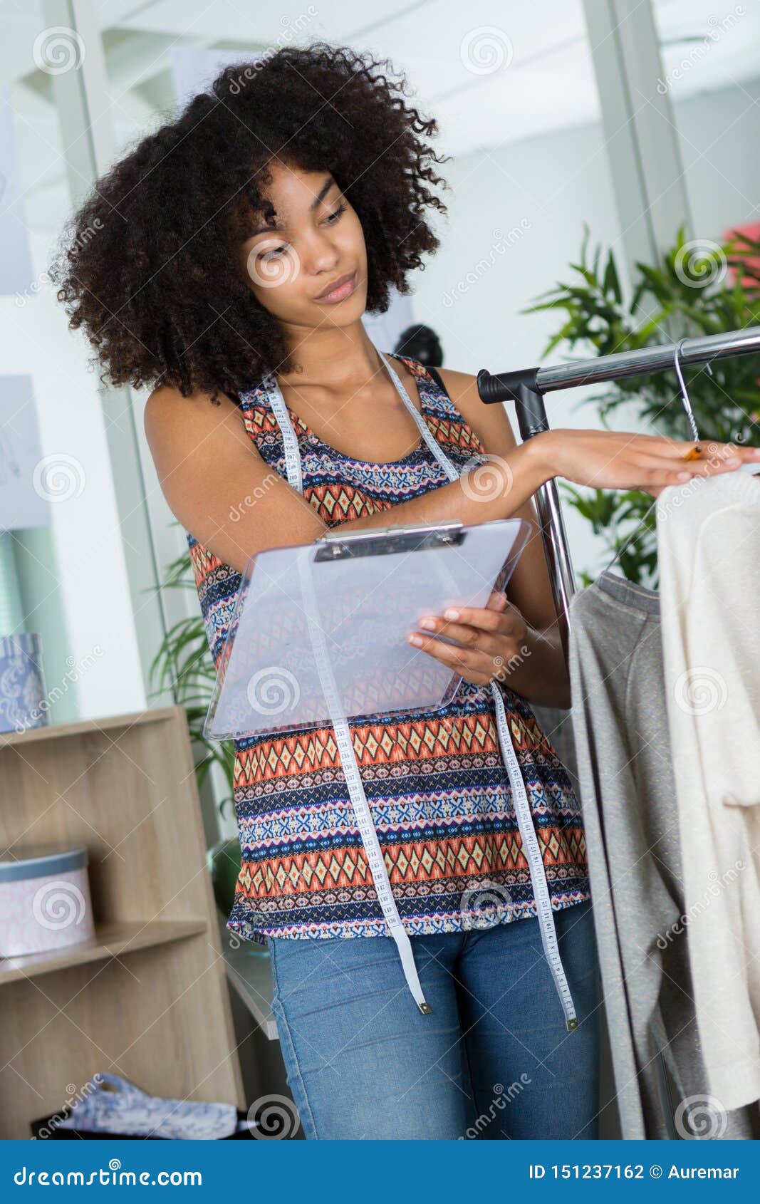 Clothes Designer Checking Garments on Rail Stock Photo - Image of ...