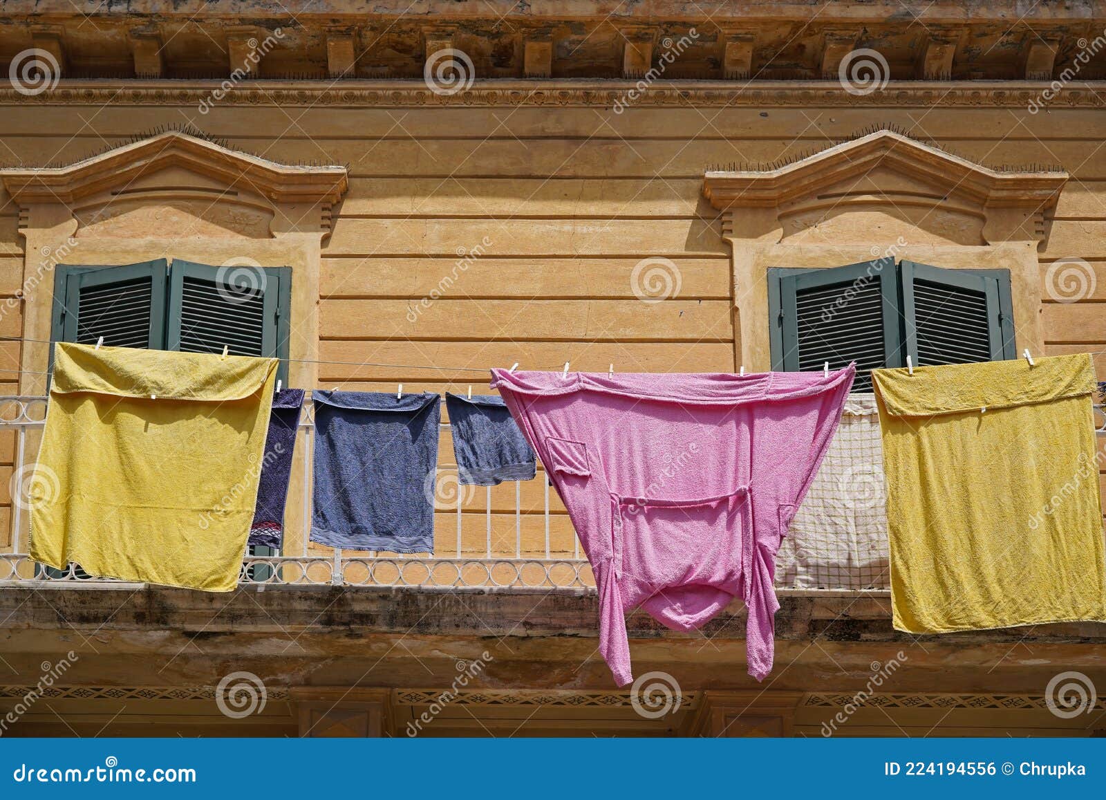 Clothes drying in the sun stock photo. Image of city - 224194556