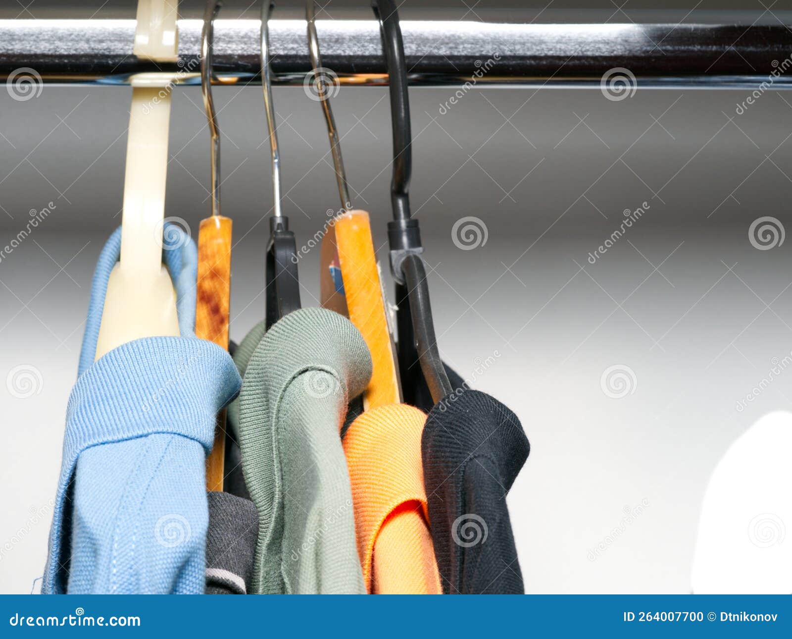 Clothes Hang on Hangers Inside the Closet. Close Stock Photo - Image of ...