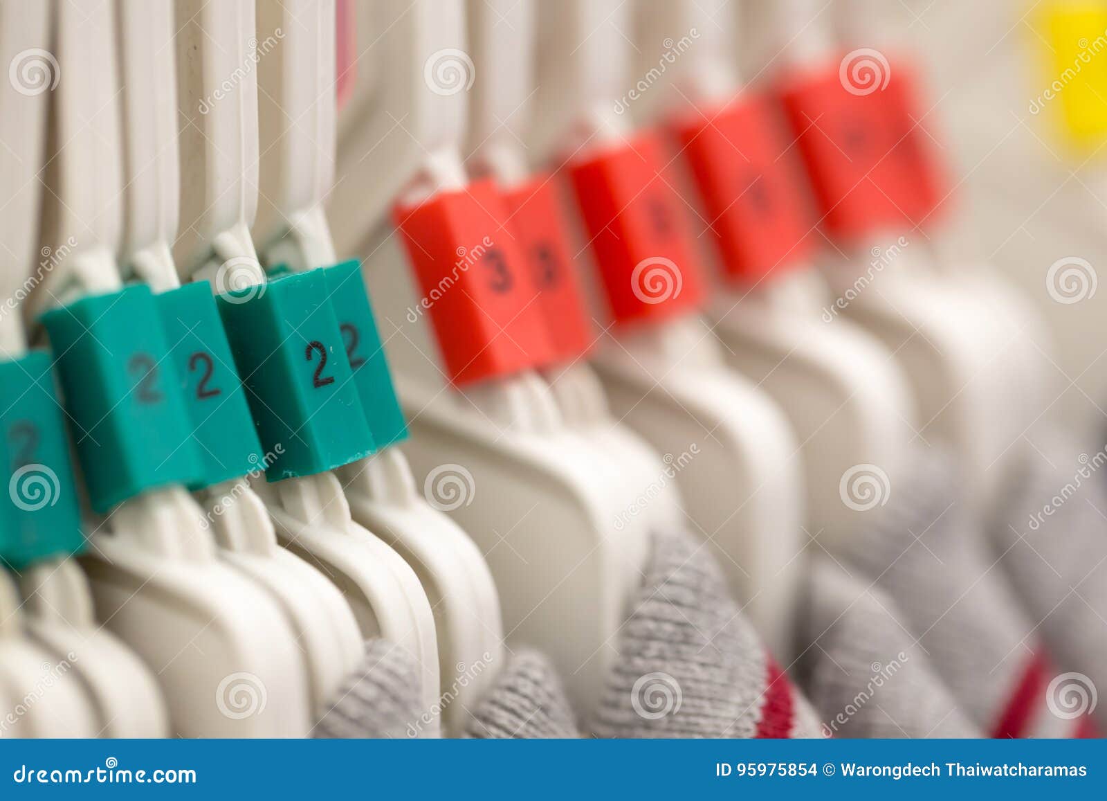 Clothes Hanger with Number Color Sizing Label. Stock Photo - Image of ...