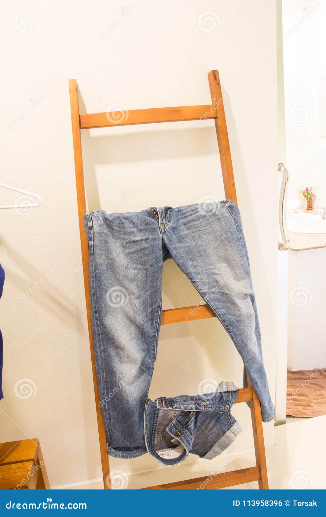 Clothes hanging on bars stock photo. Image of rack, wall - 113958396