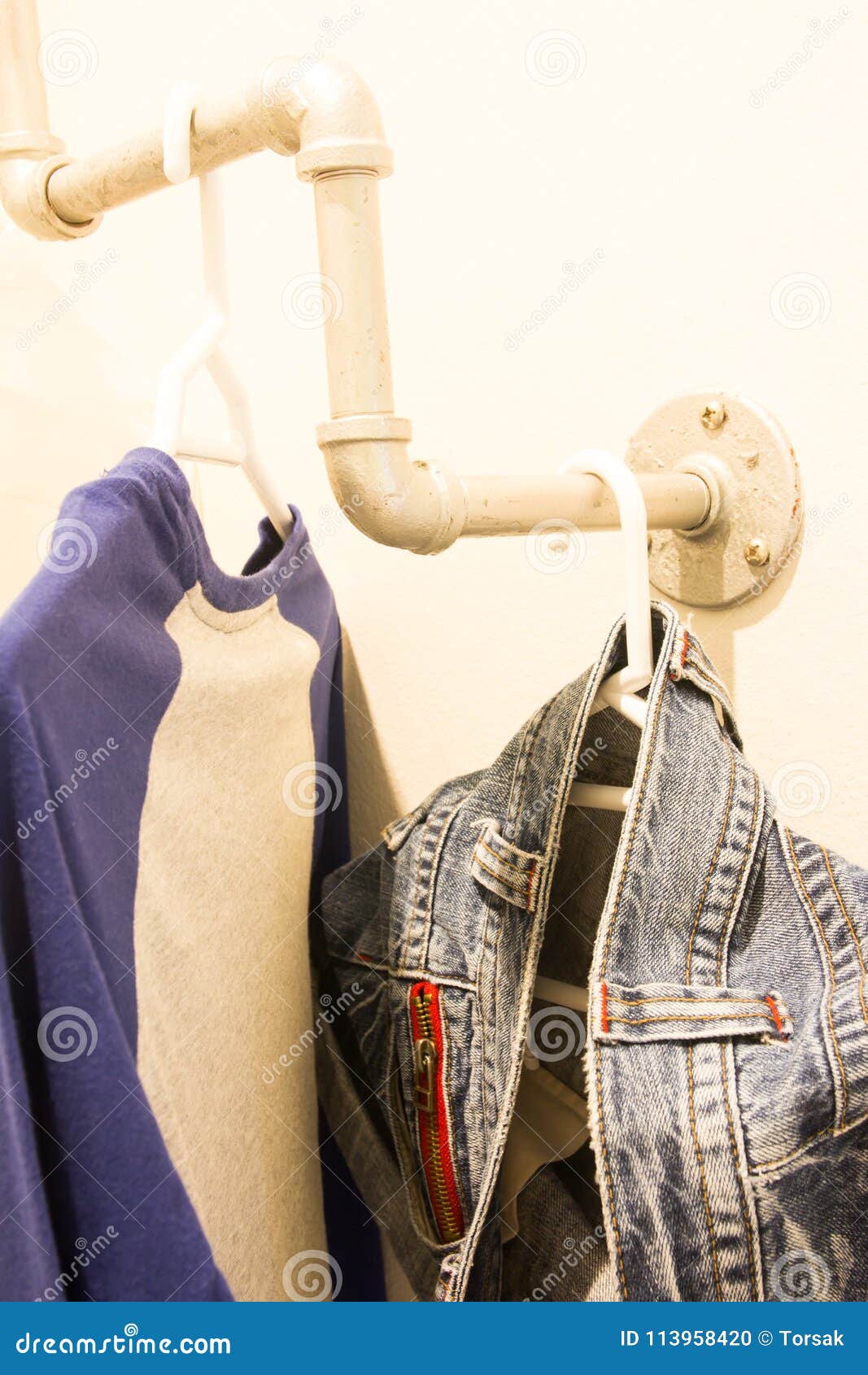 Clothes hanging on bars stock photo. Image of clothe - 113958420