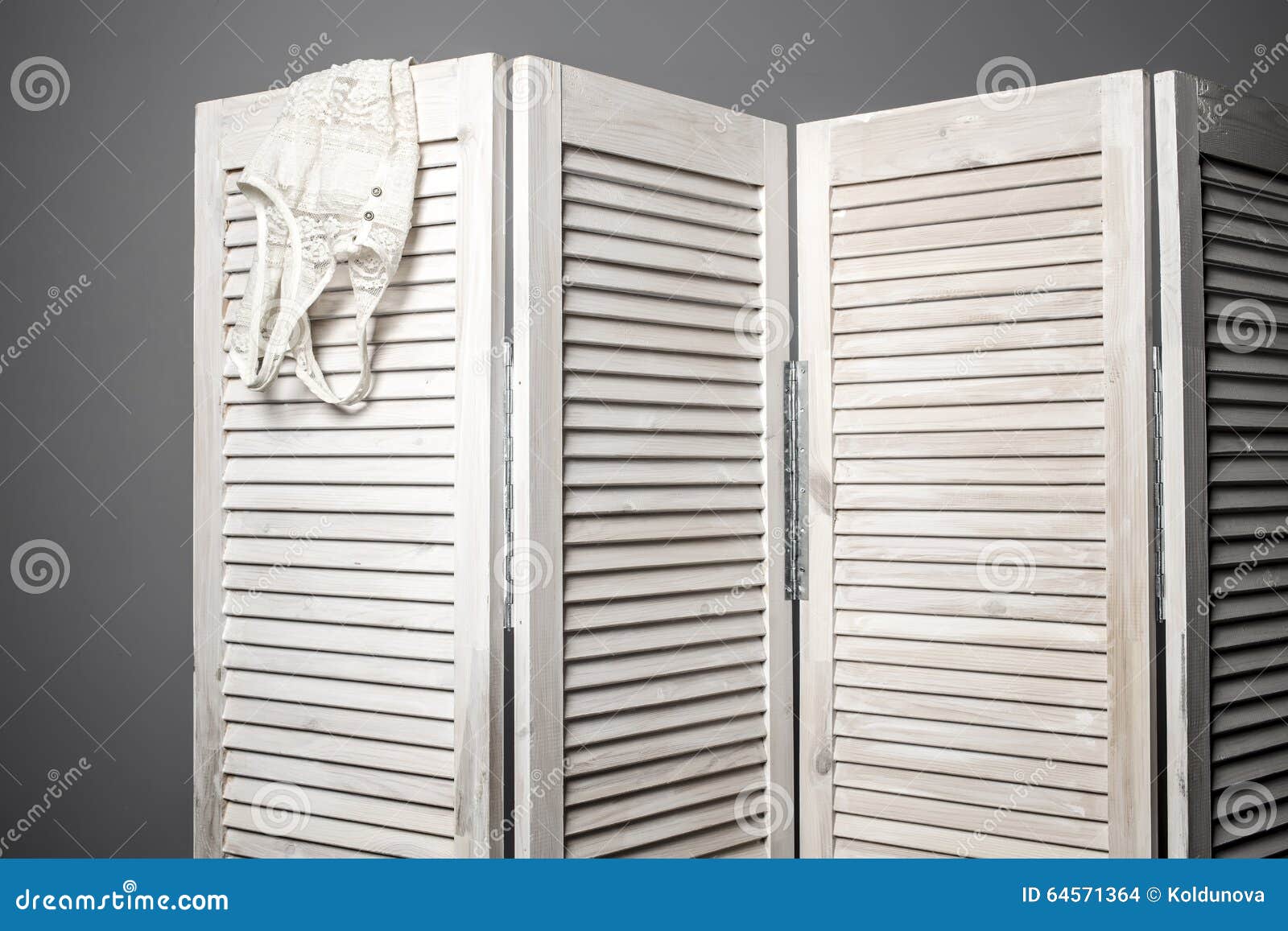 Clothes Hanging on the White Folding Screen Stock Photo - Image of ...