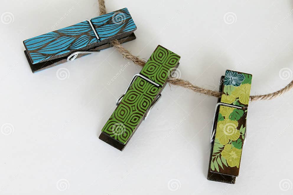 Decorative Wooden Clothes Pins with Patterns Hanging on Twine Stock ...