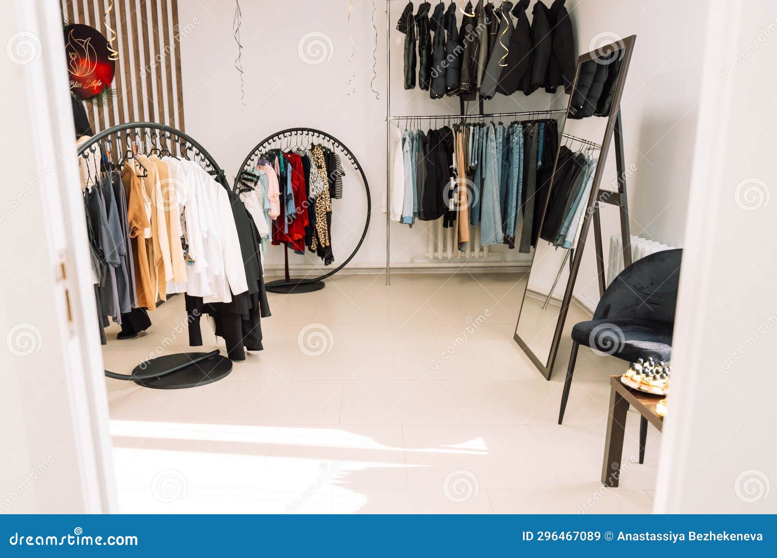 Clothes Store with Racks of Clothes and a Large Mirror Stock Image ...