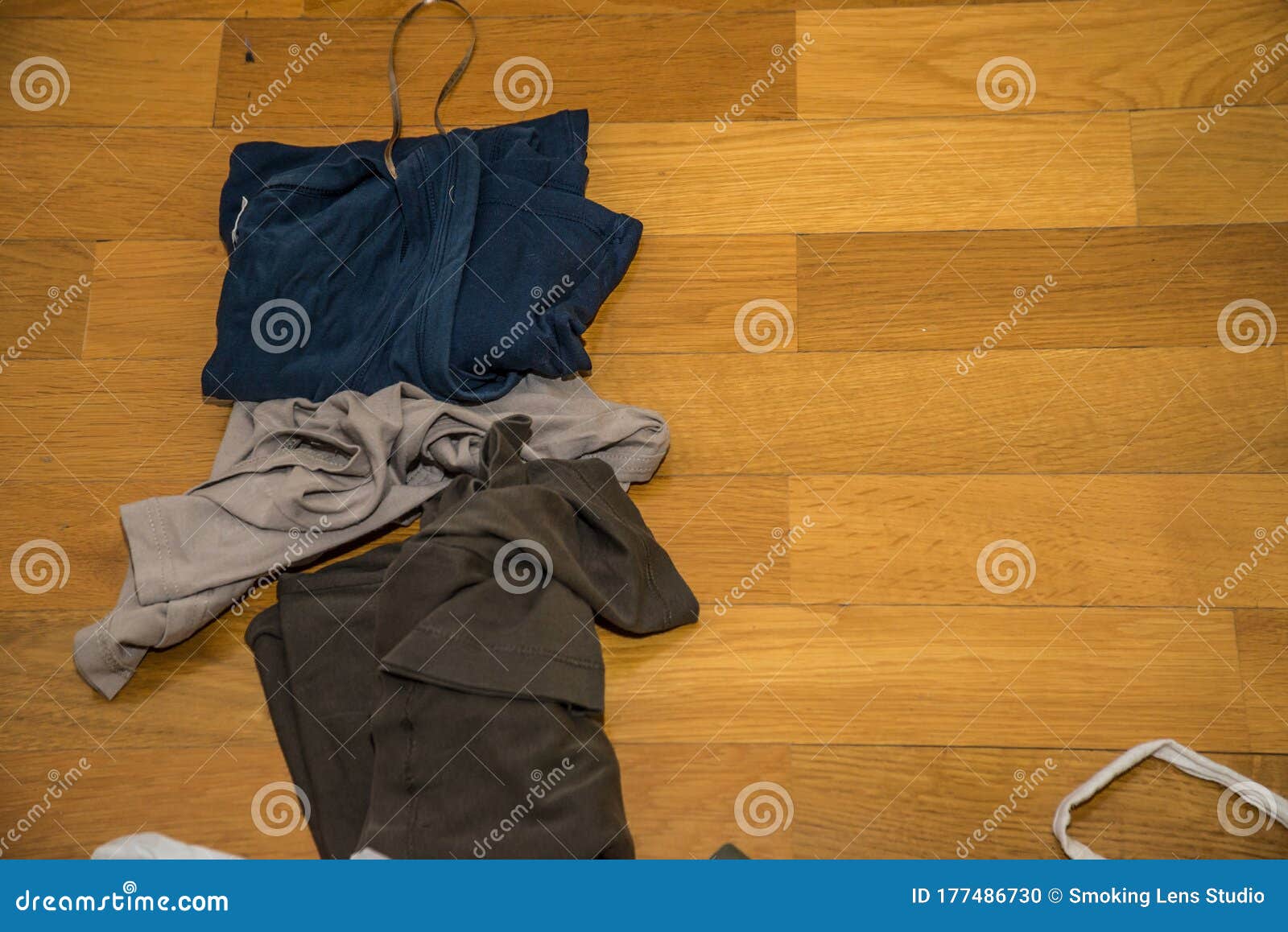 Clothes on wooden floor stock photo. Image of closeup - 177486730