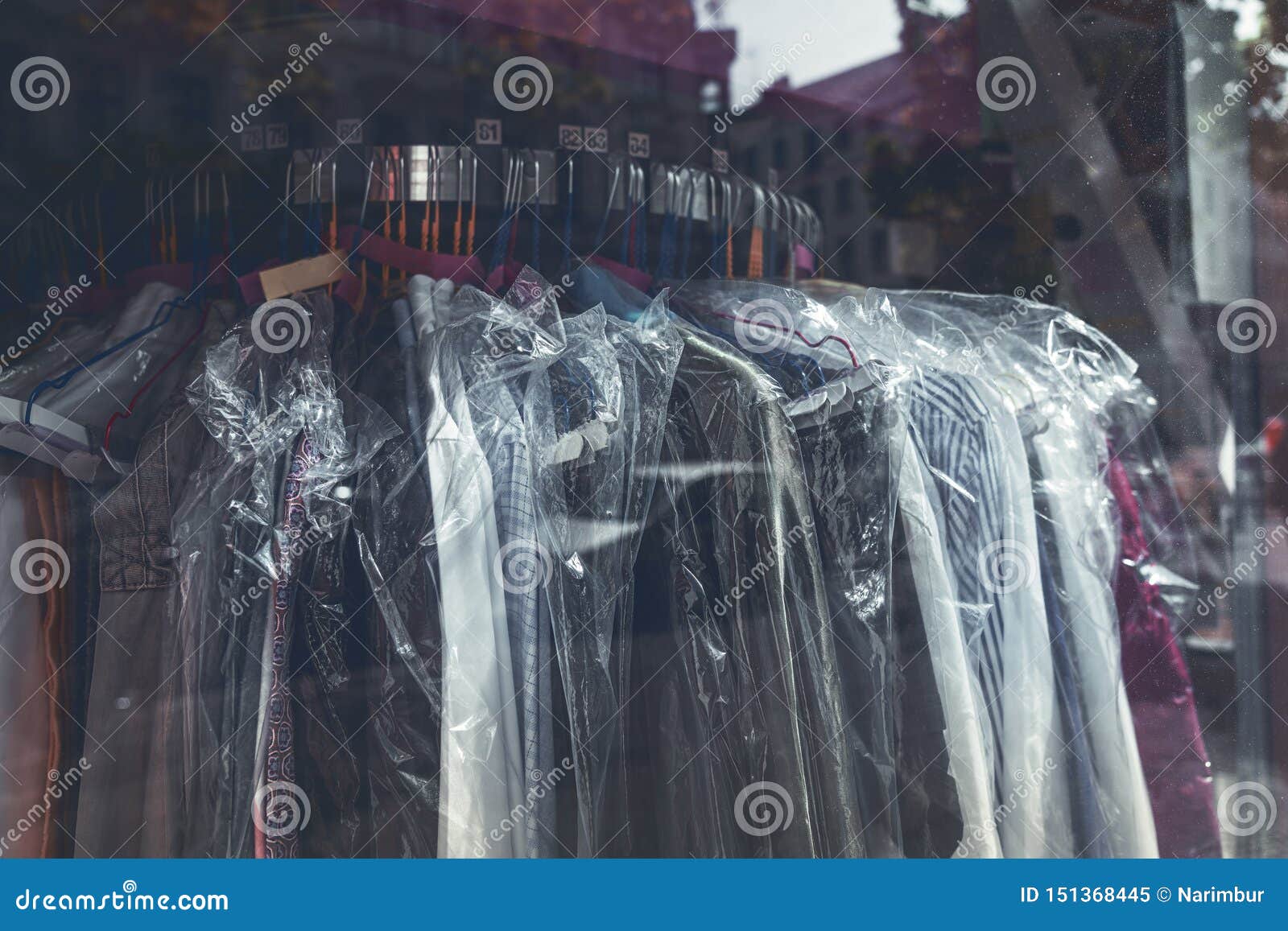 Clothes Wrapped with Plastic on a Rack Stock Image - Image of ...
