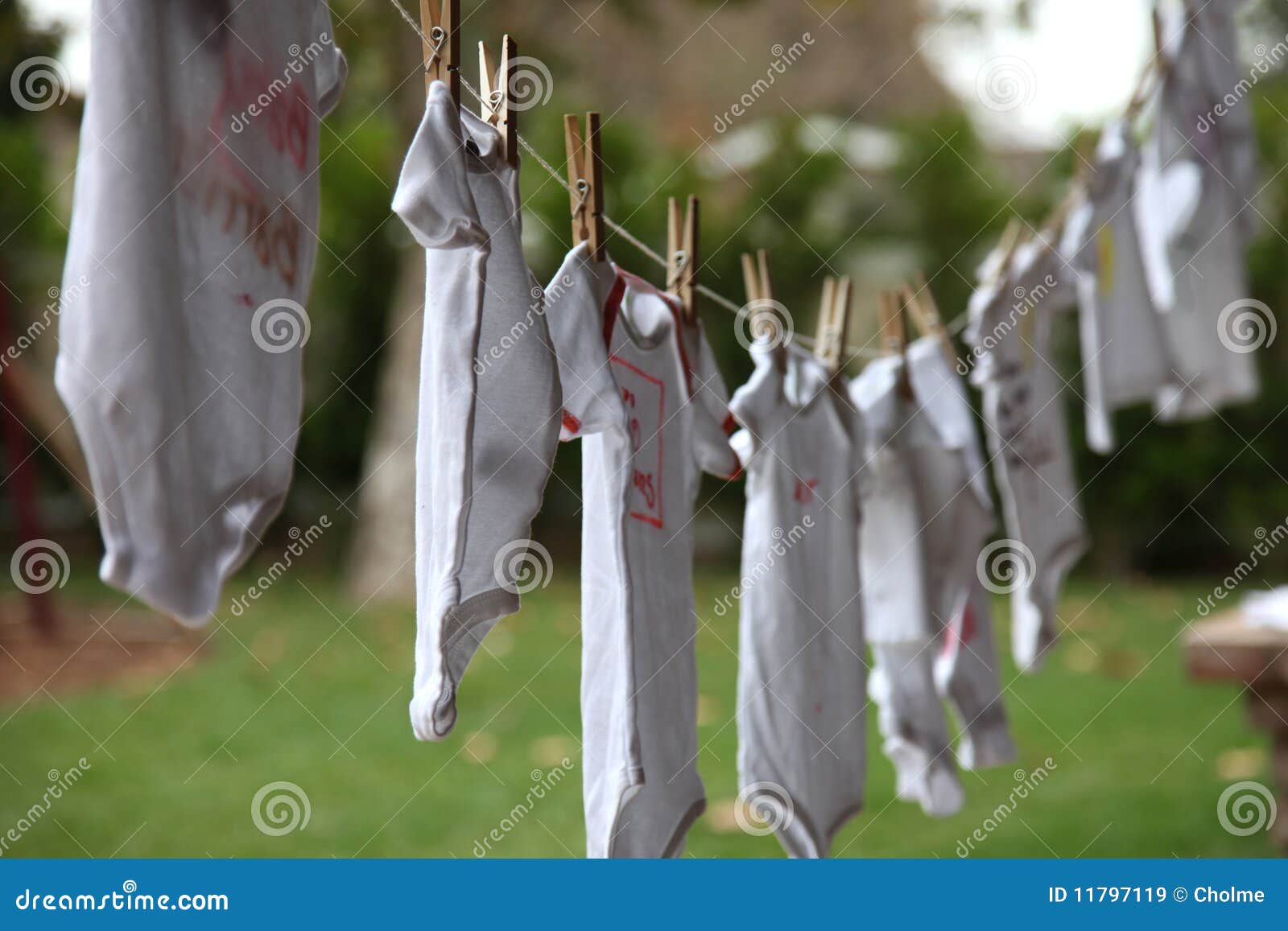 Clothesline of onesies stock image. Image of bright, white - 11797119