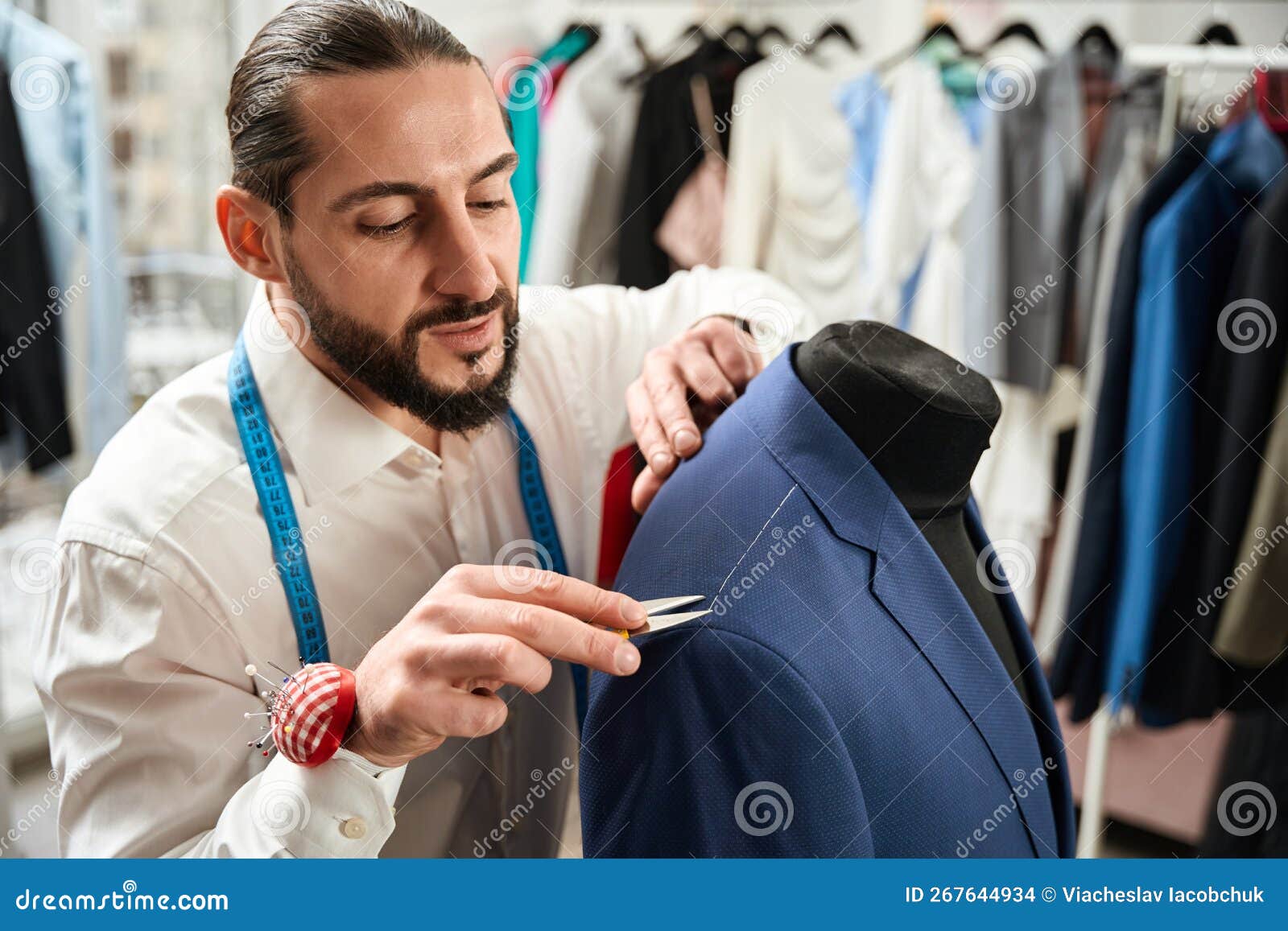 Clothier Removing White Stitches from Client Suit Stock Photo - Image ...