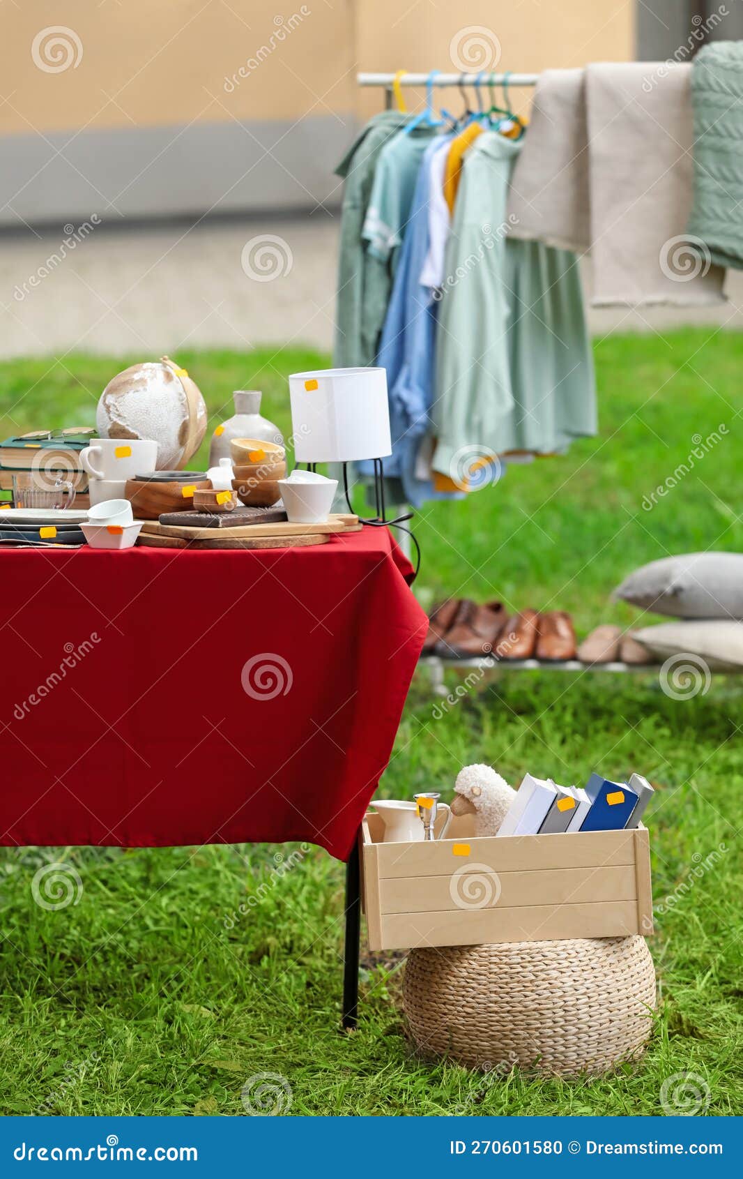Clothing Rack and Table with Different Items on Garage Sale in Yard ...