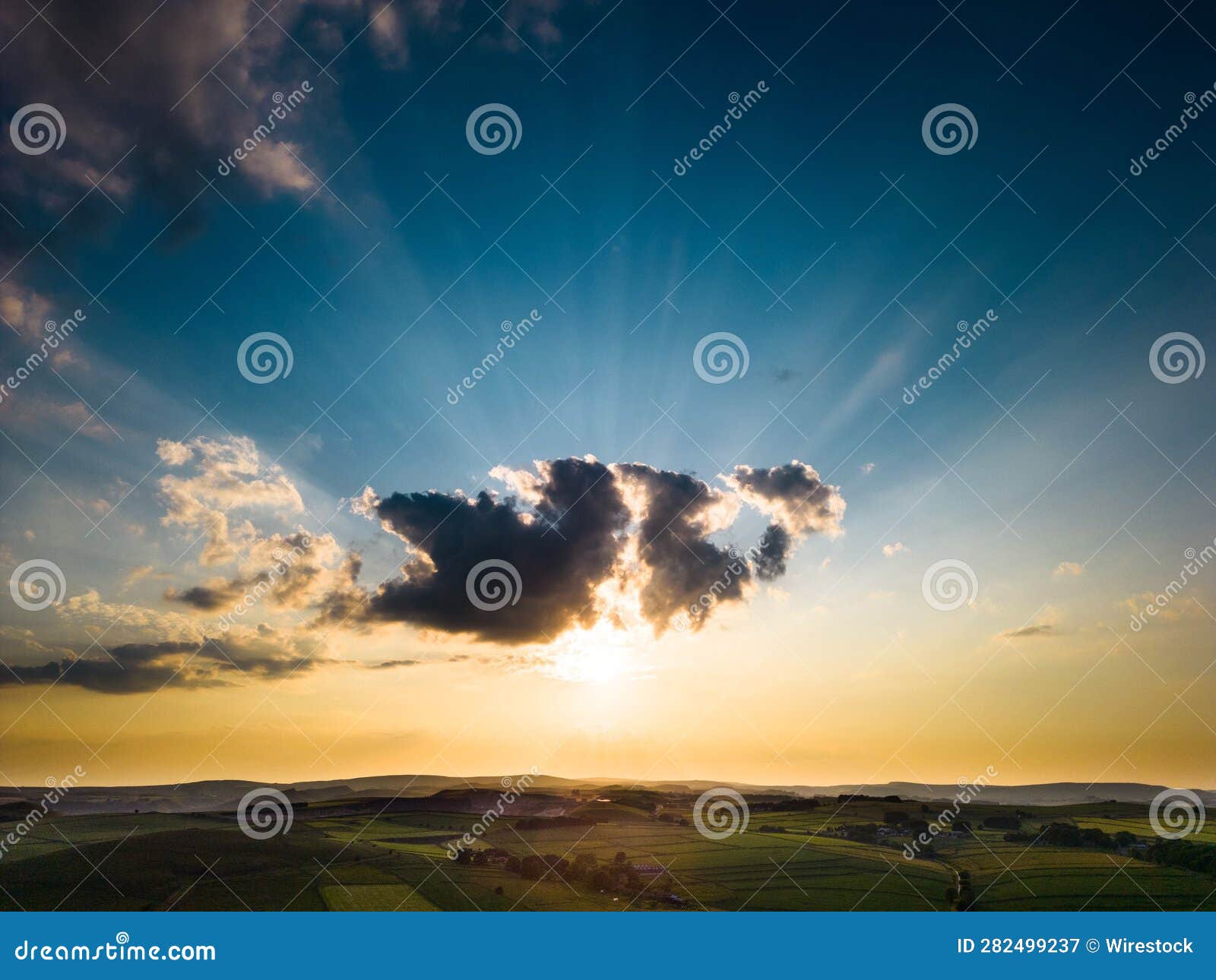 Cloud Backlit by Sunset with Rays of Sunshine Going Upwards. Stock ...