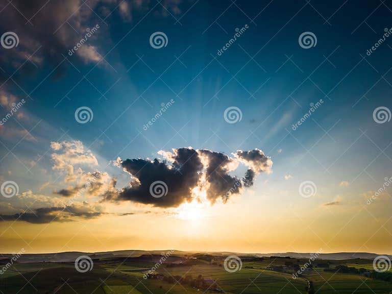 Cloud Backlit by Sunset with Rays of Sunshine Going Upwards. Stock ...