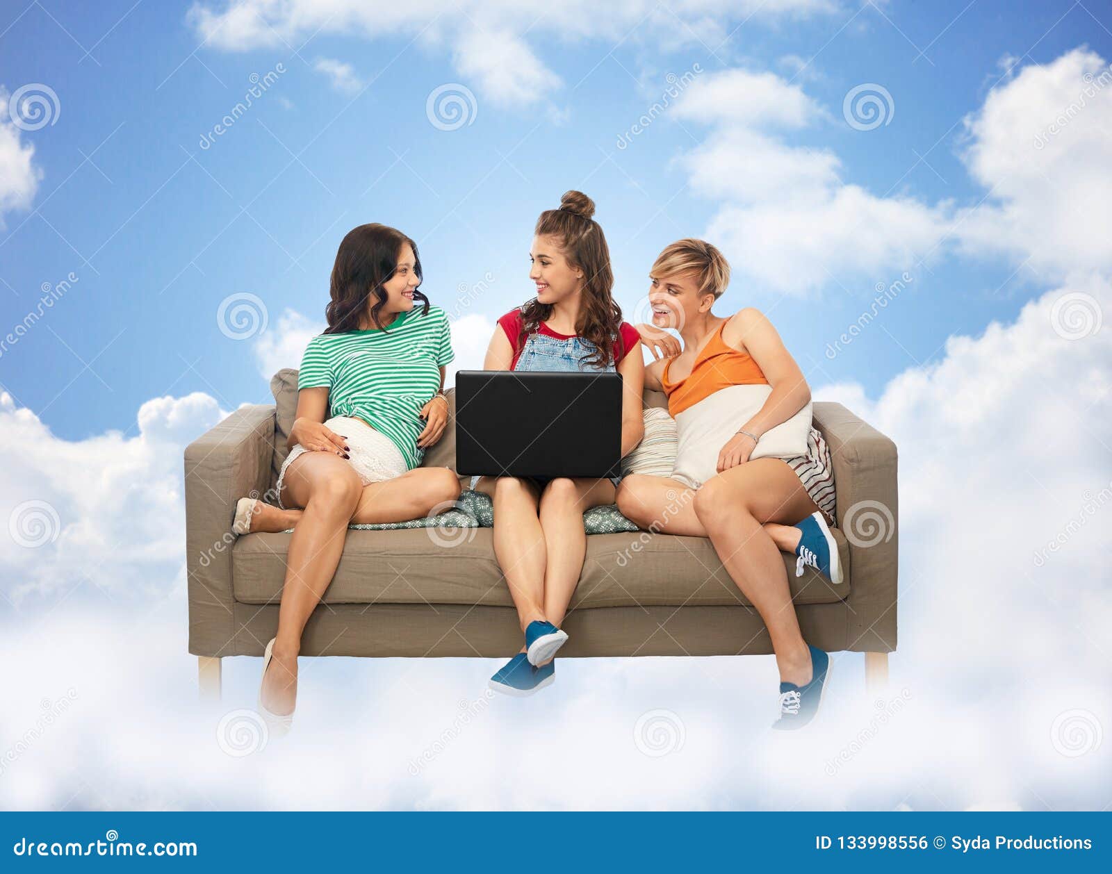Female Friends with Laptop Computer Over Clouds Stock Photo - Image of ...