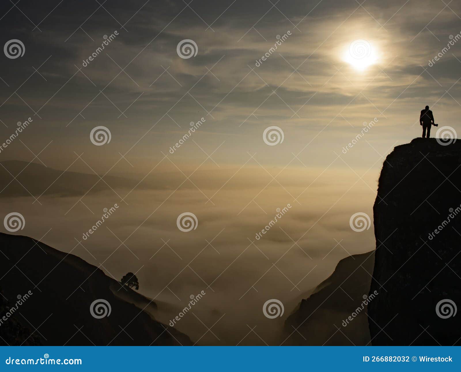 Cloud Inversion Peak with Tree and Man in Silhouette during Sunset ...