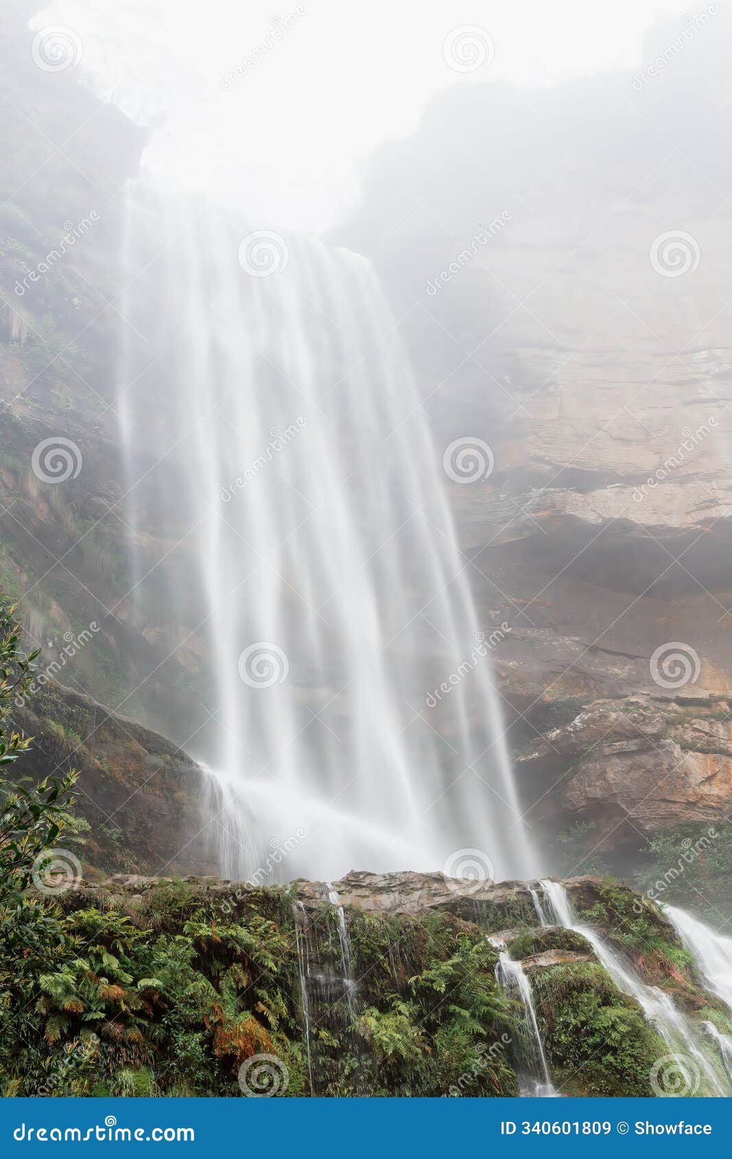 Cloud Mist and Full Flowing Waterfall Flowing Off a High Cliff Stock ...