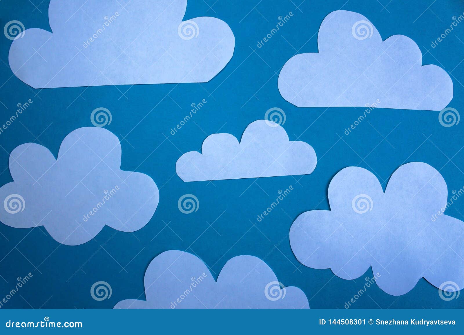 Cut Out of Paper Clouds Lie on a Blue Background Stock Image - Image of ...