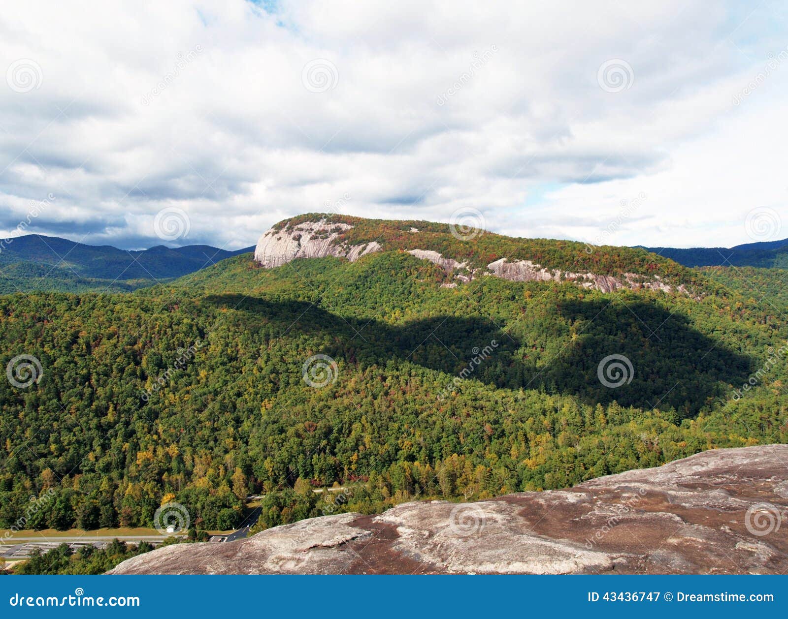 Cloud Shadow Over Mountain Range with Trees and Bright Sun Stock Image ...