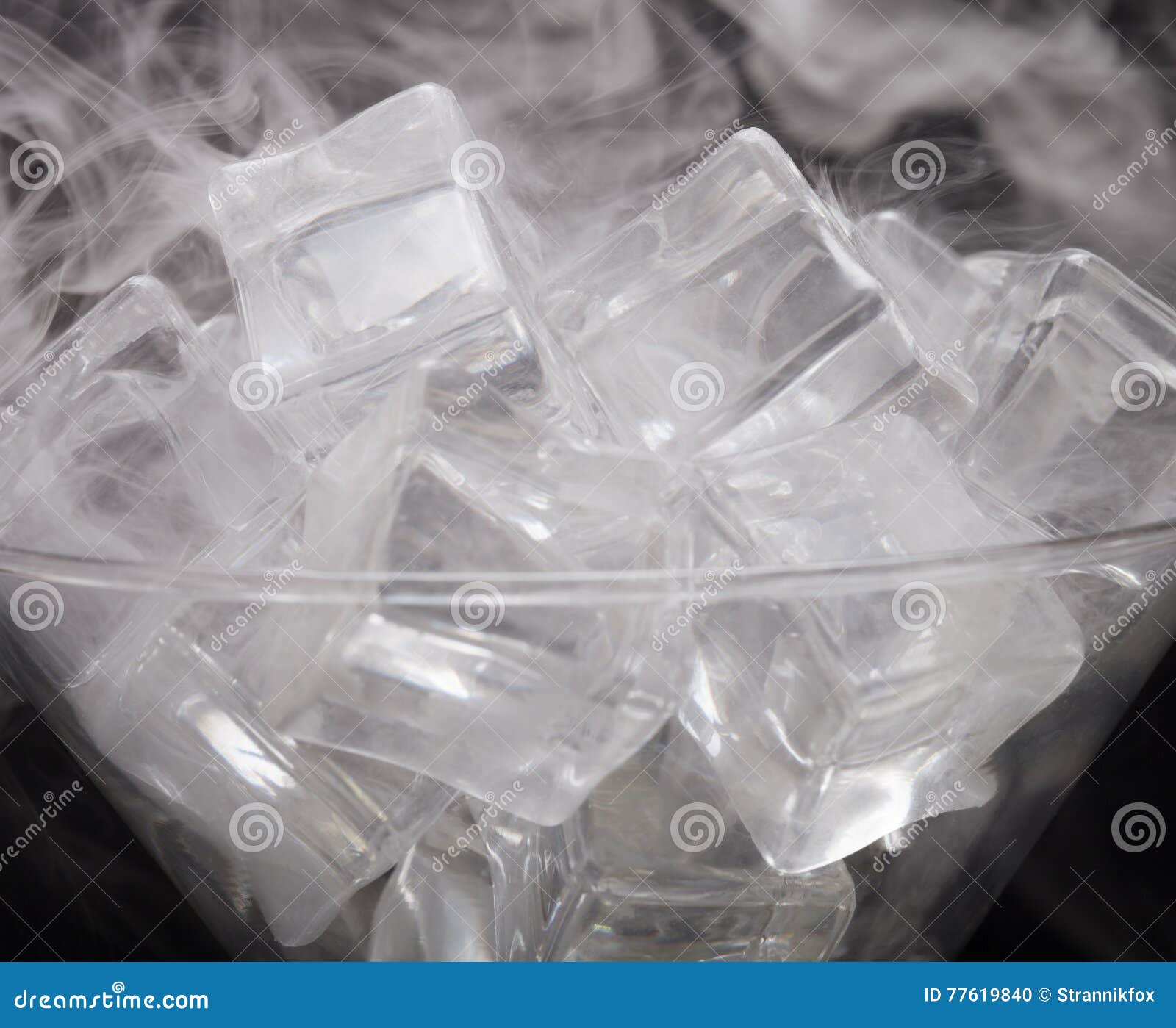 Cloud of Smoke Over Martini Glass with Ice Cubes on Black Background ...
