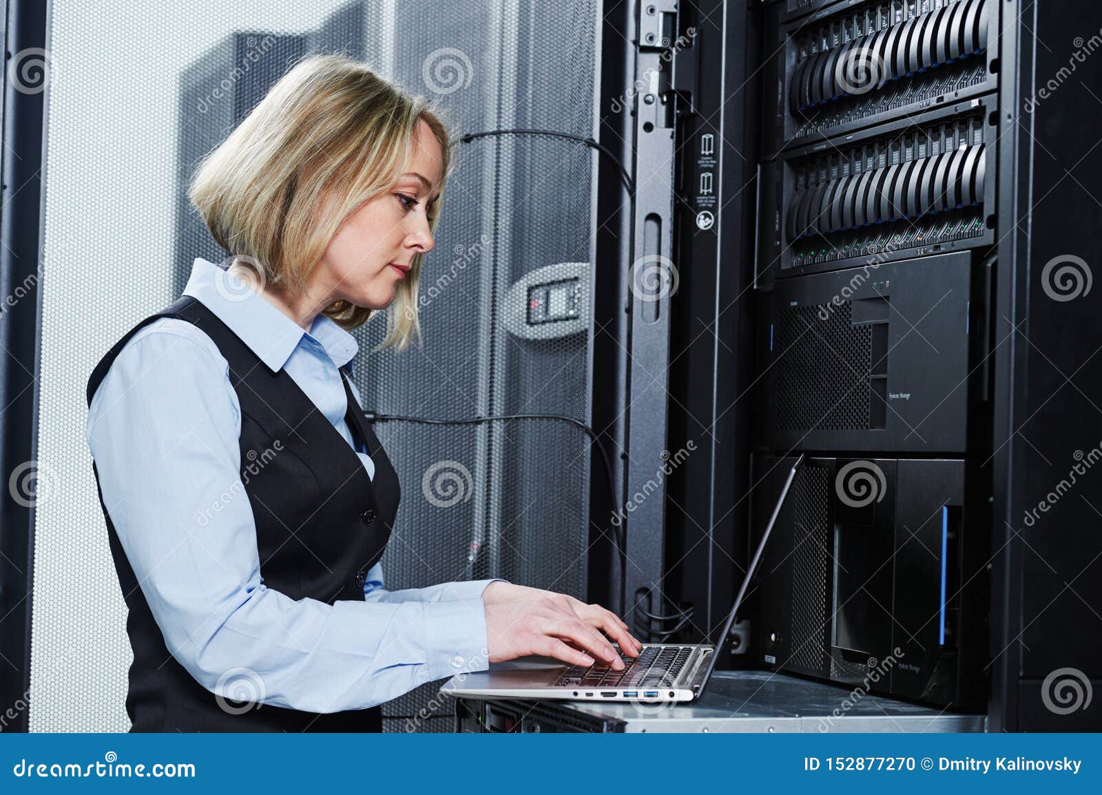 Cloud Storage Service. Female Engineer Works with Laptop in Data Center ...