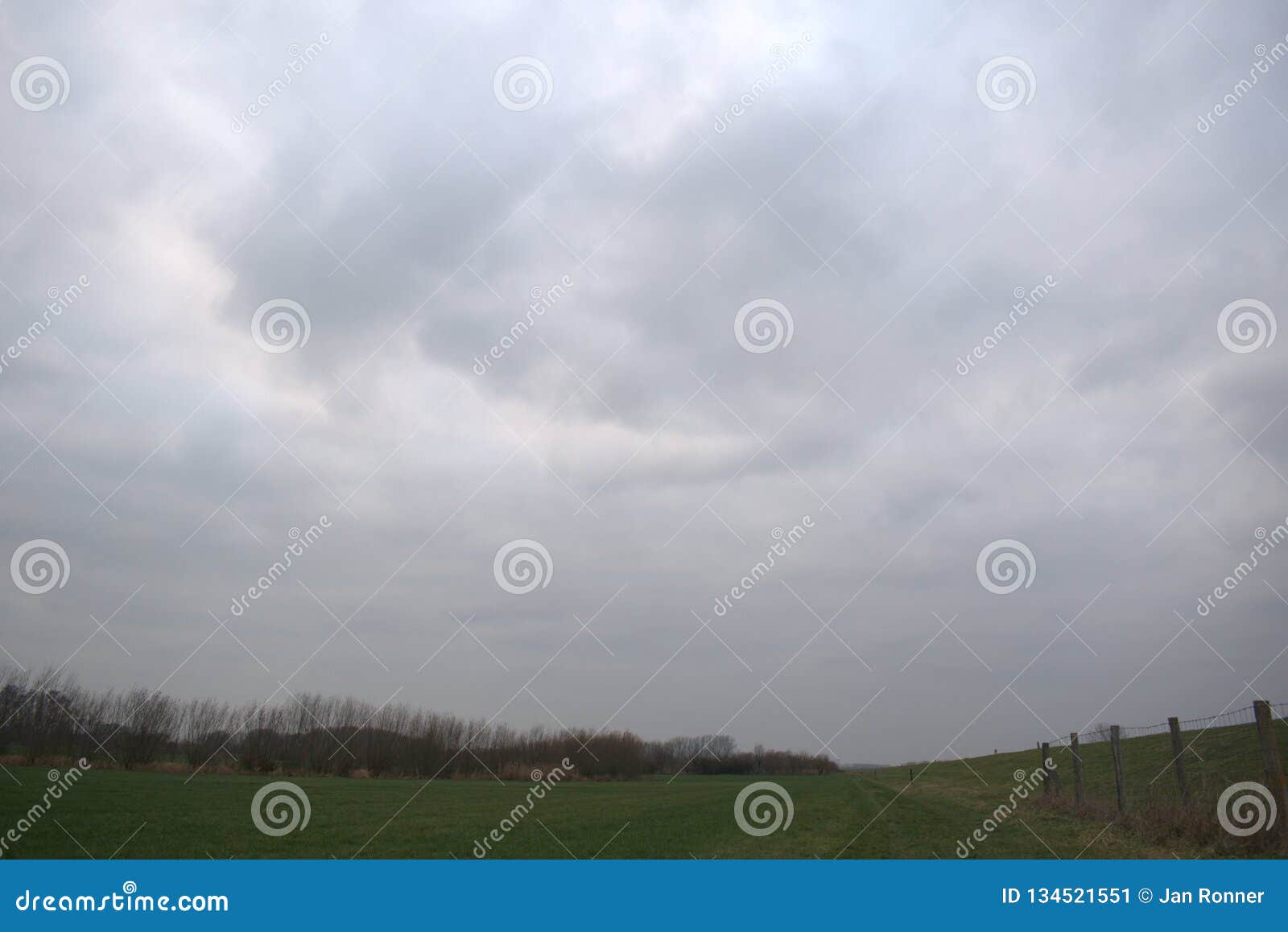 Dramatic Cloud Sky Over a Grass Field Stock Image - Image of trees ...