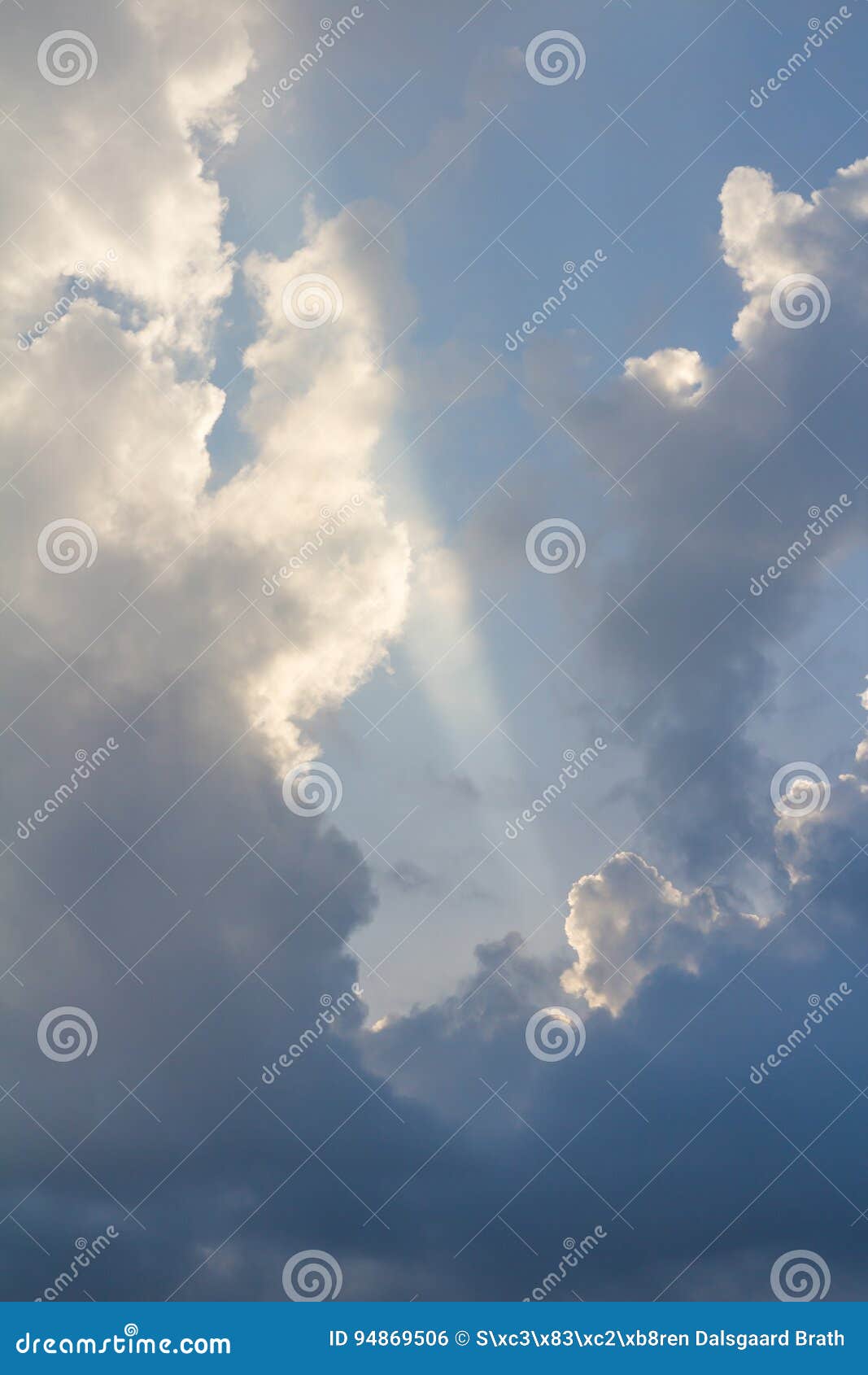 Clouds on Blue Sky Pierced by Ray of Sunlight, Vertical Stock Photo ...