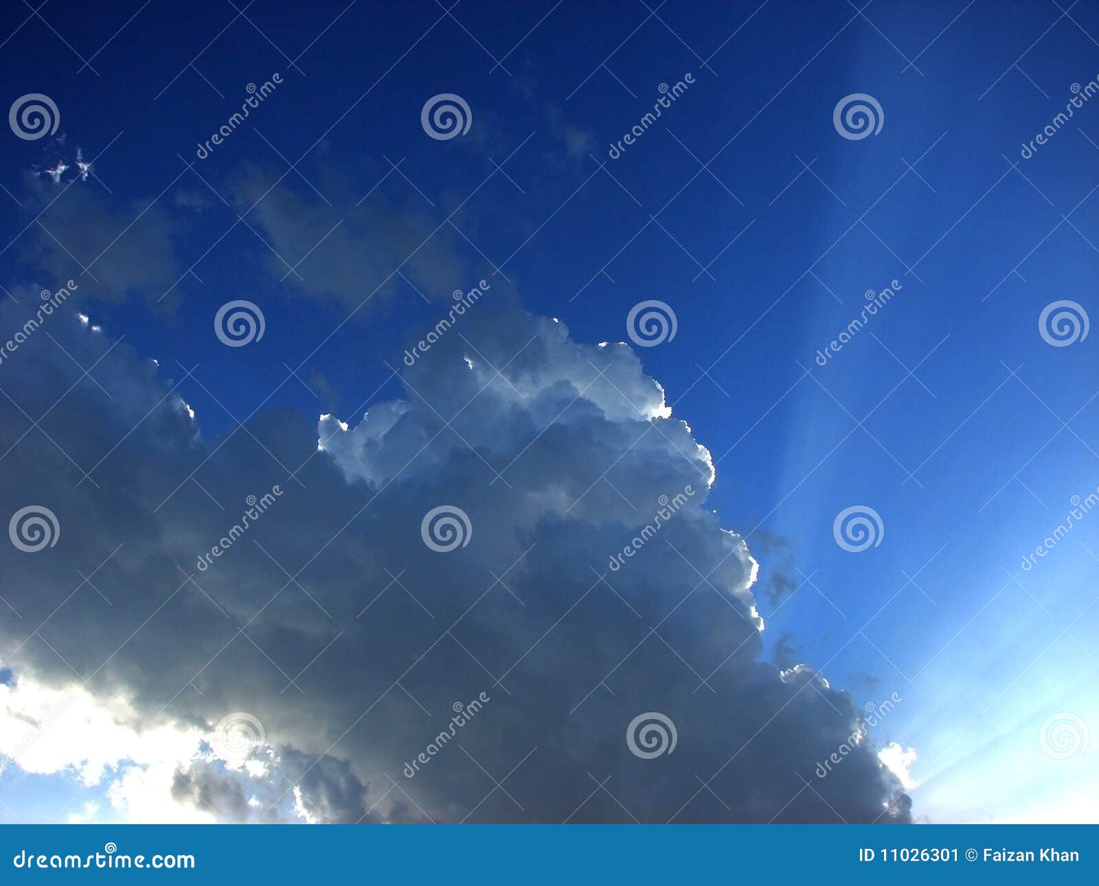 Clouds and a Blue Sky and Sunbeam Shining through Stock Image - Image ...