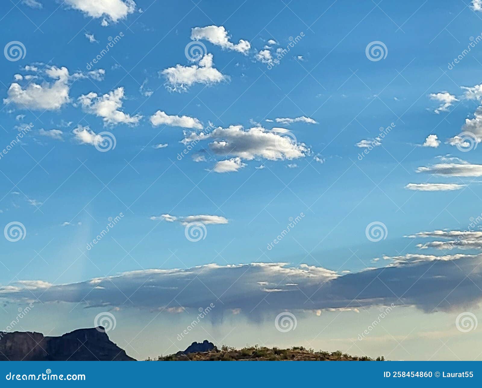 Clouds Drop Rain on the Landscape Under a Sky of Blue! Stock Photo ...