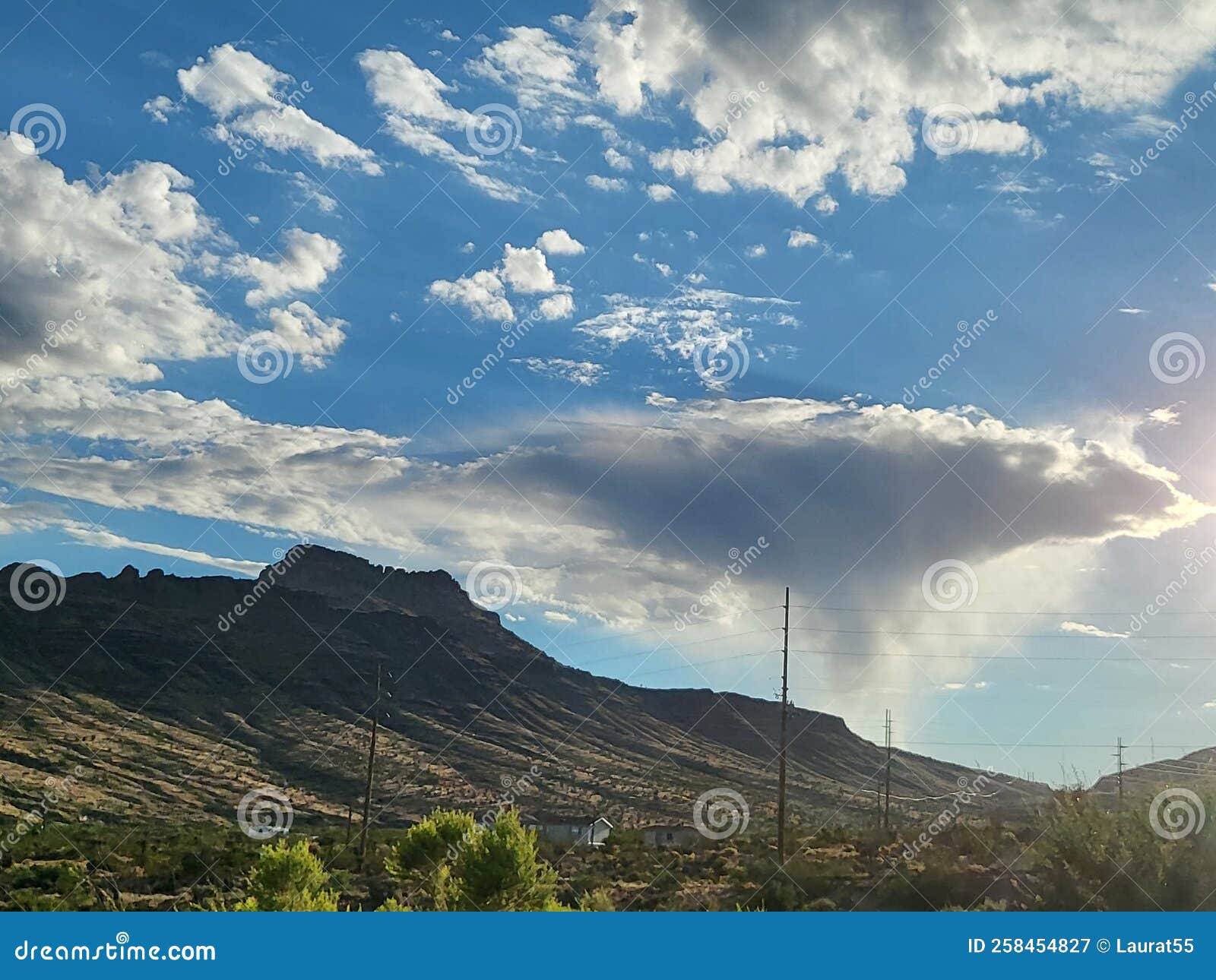 Clouds Hang Over the Hills in the Blue Sky Above Funnel Storm Cloud ...