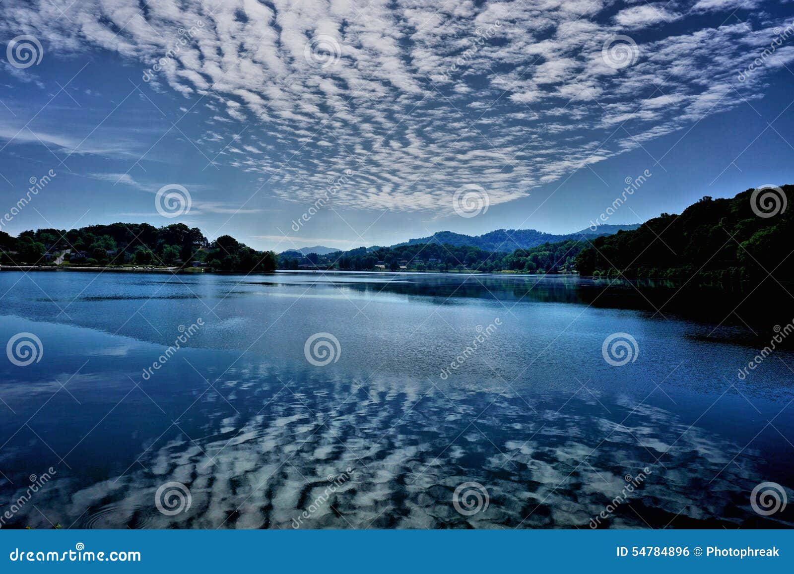 Clouds over still lake stock photo. Image of shoreline - 54784896
