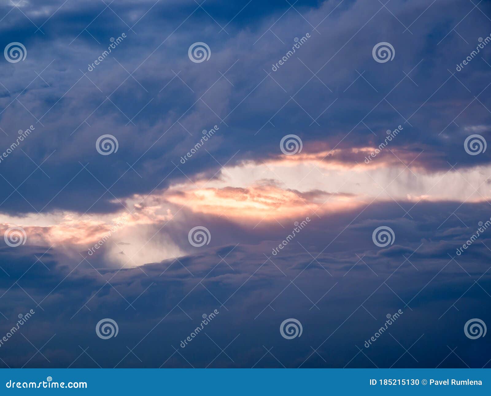 Clouds Surrounding a Bright Rift in the Sky at Sunrise Stock Photo ...