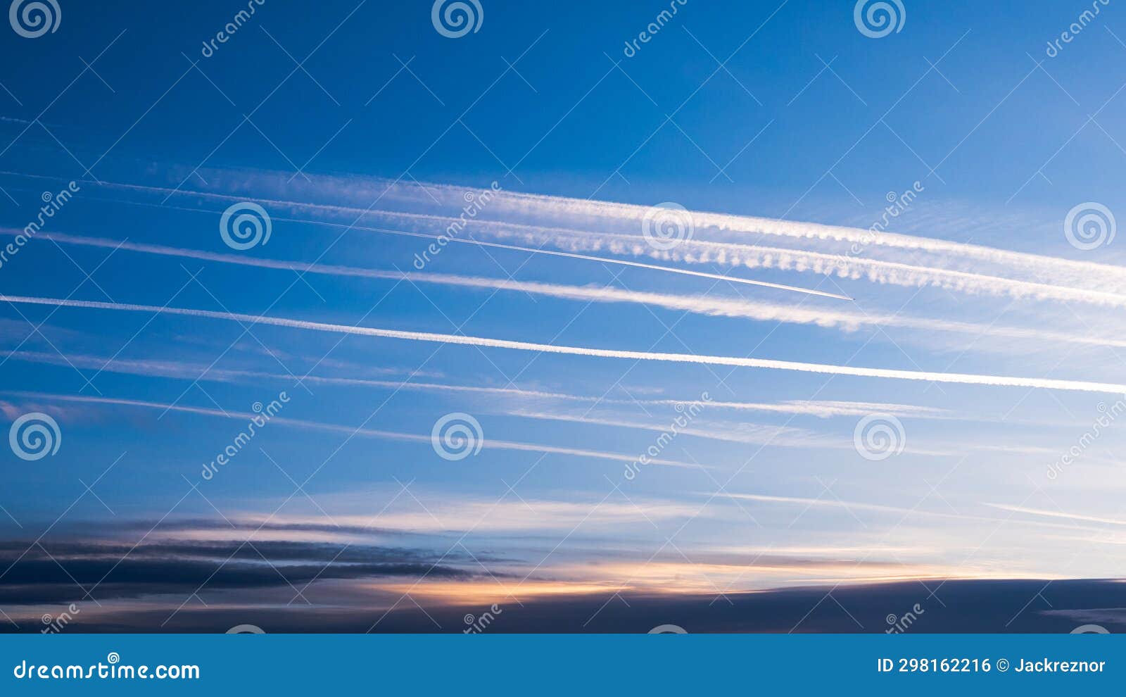 Jet Plane And Vapor Trails Going Straight Up Across A Cloudy Deep Blue ...