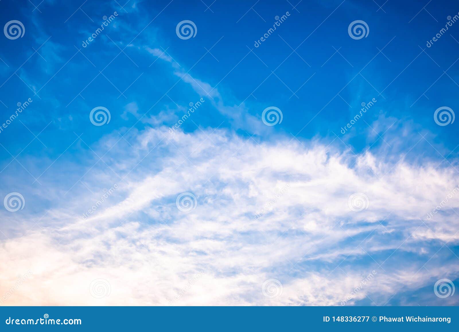 Cloudy Blue Sky with Status Clouds and Orange Rays of Light at the ...