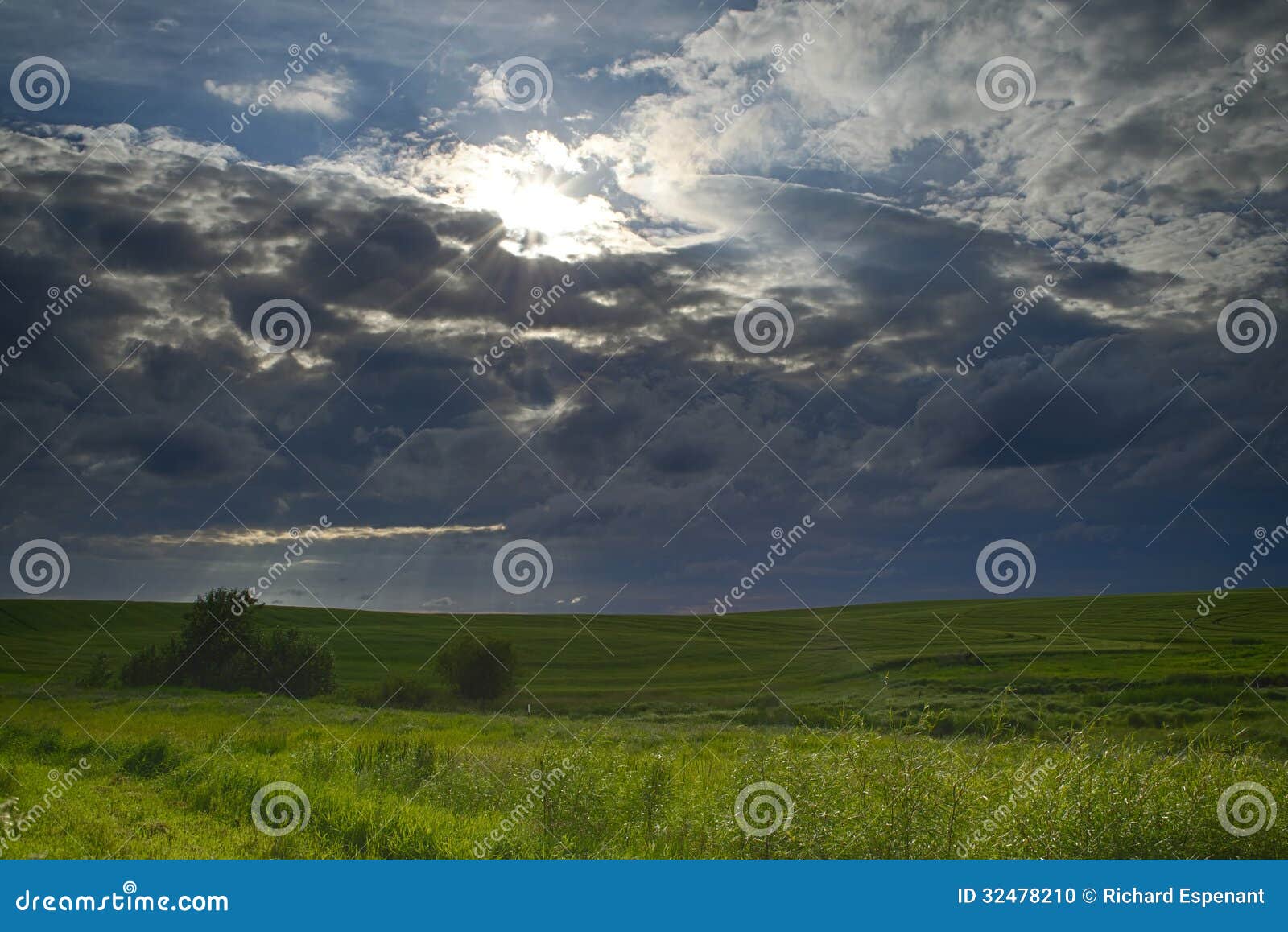 Cloudy Day with a Little Sun Shining Over Green Fields Stock Photo ...